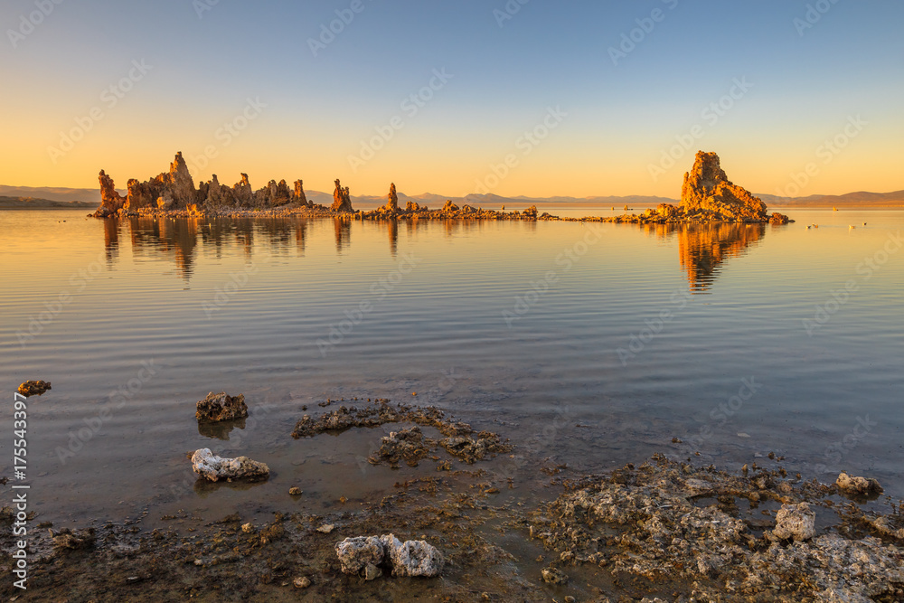 The calcareous tufa formation reflects on the smooth waters of Mono ...
