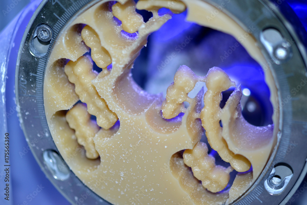 Dental milling machine carving out shape of human teeth close-up ...