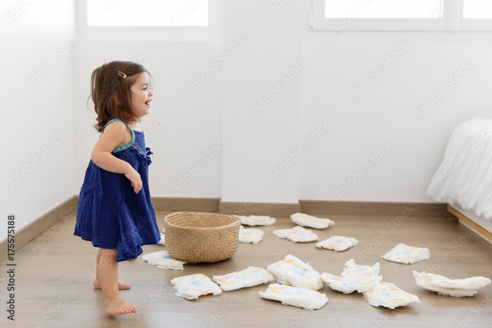 baby girl making mess with diapers on bedroom floor Stock Photo | Adobe ...