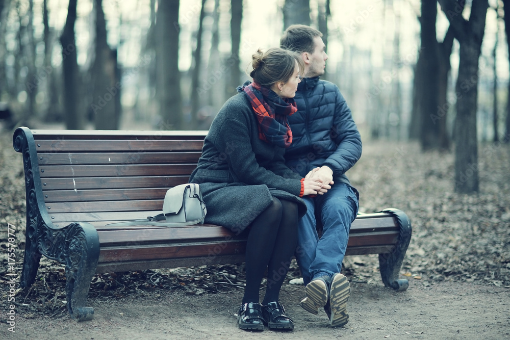 couple cuddling on a bench in winter Stock Photo | Adobe Stock