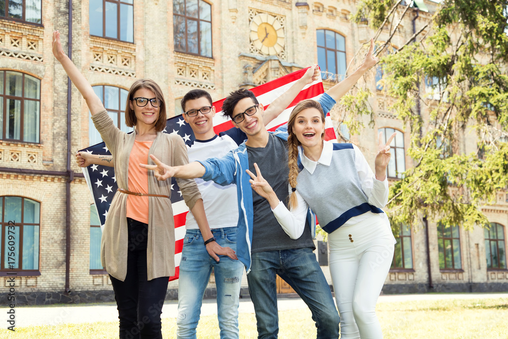 Group of students holding flag of USA on the university campus. Group ...