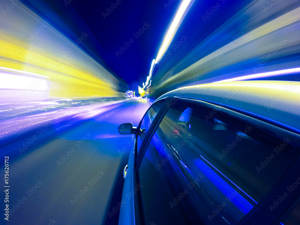 Car driving fast in the night city Stock Photo | Adobe Stock