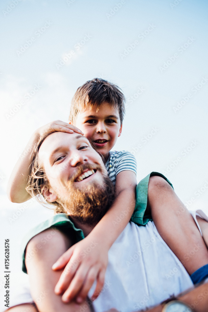 Older brother carrying a younger brother on his back Stock Photo ...