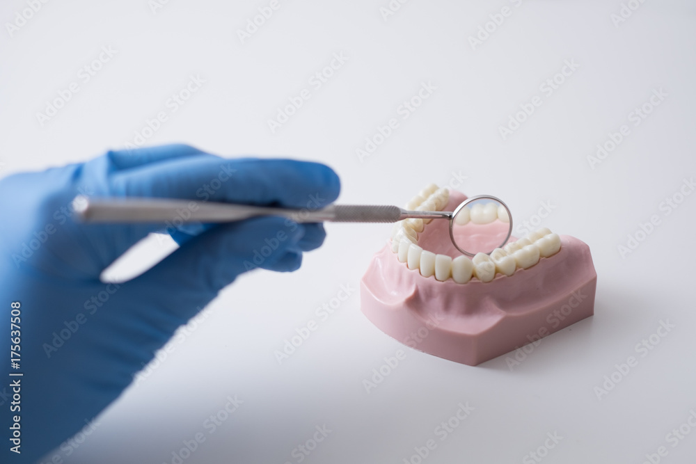 Dentist hand and instrument during a cavity tooth examination on a ...
