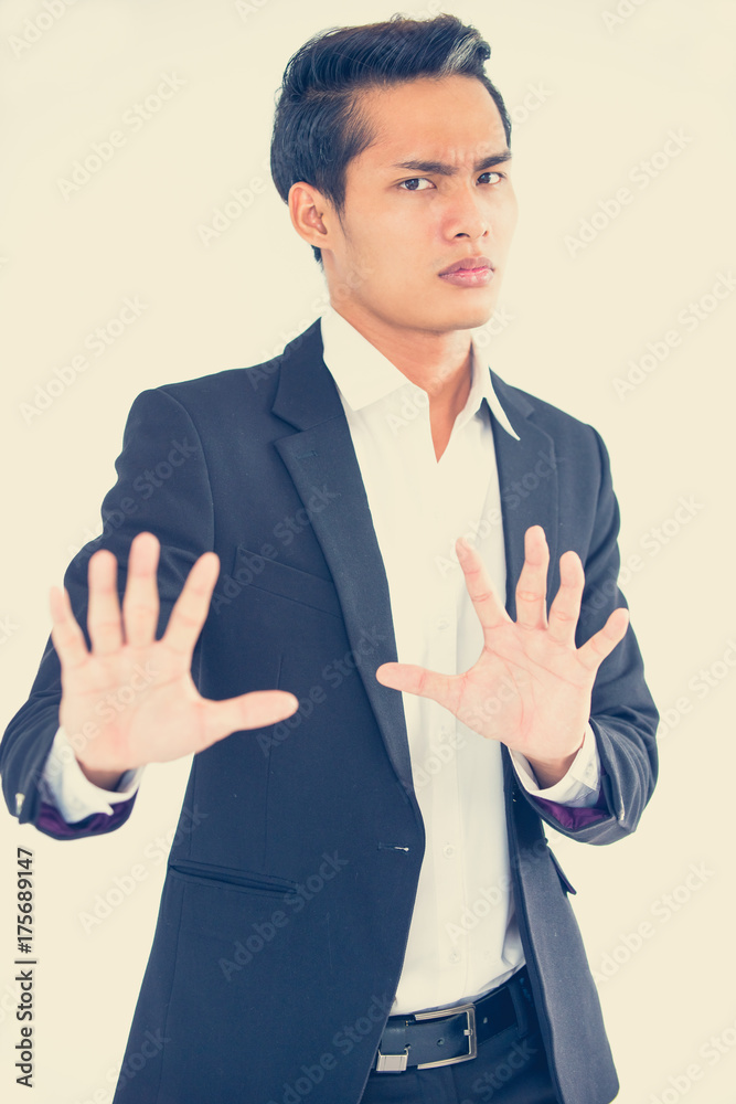 Confused Asian businessman showing stop gesture Stock Photo | Adobe Stock