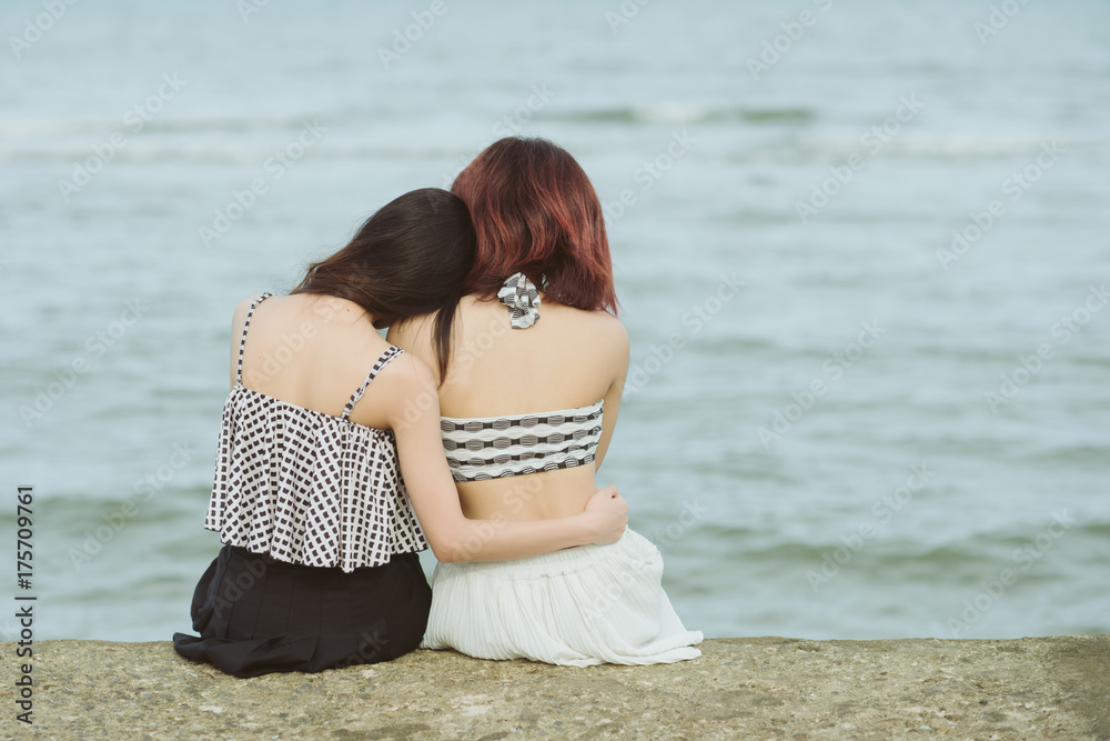 View from behind of two girlfriends or a lesbian couple . Two woman ...