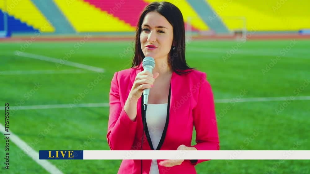 The journalist is reporting from the stadium for television with ...