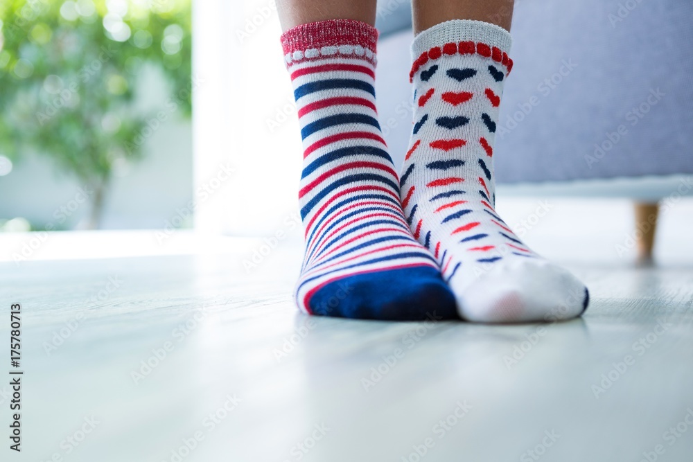 Low section of girl wearing different socks Stock Photo | Adobe Stock