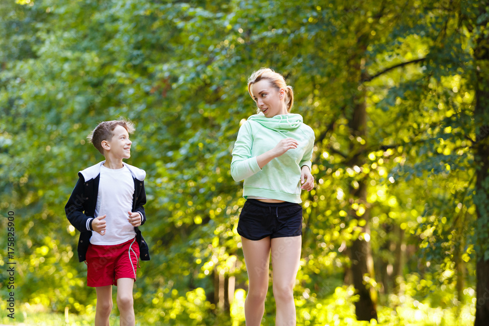 Young family jogging in the open air Happy mom with 9 years old child ...