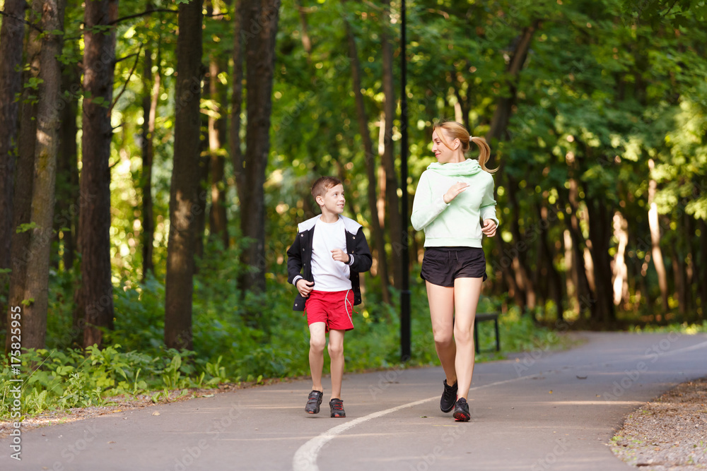 Young family jogging in the open air Happy mom with 9 years old child ...