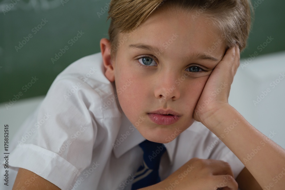 Schoolboy relaxing in classroom Stock Photo | Adobe Stock