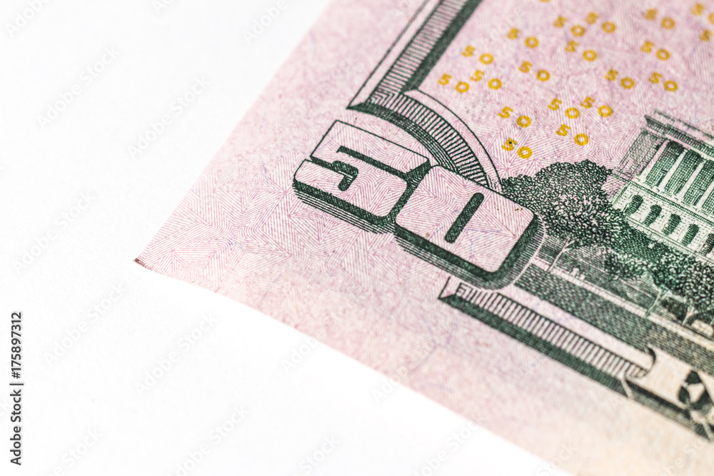 The corner of a fifty dollar bill of the USA close-up on a white ...