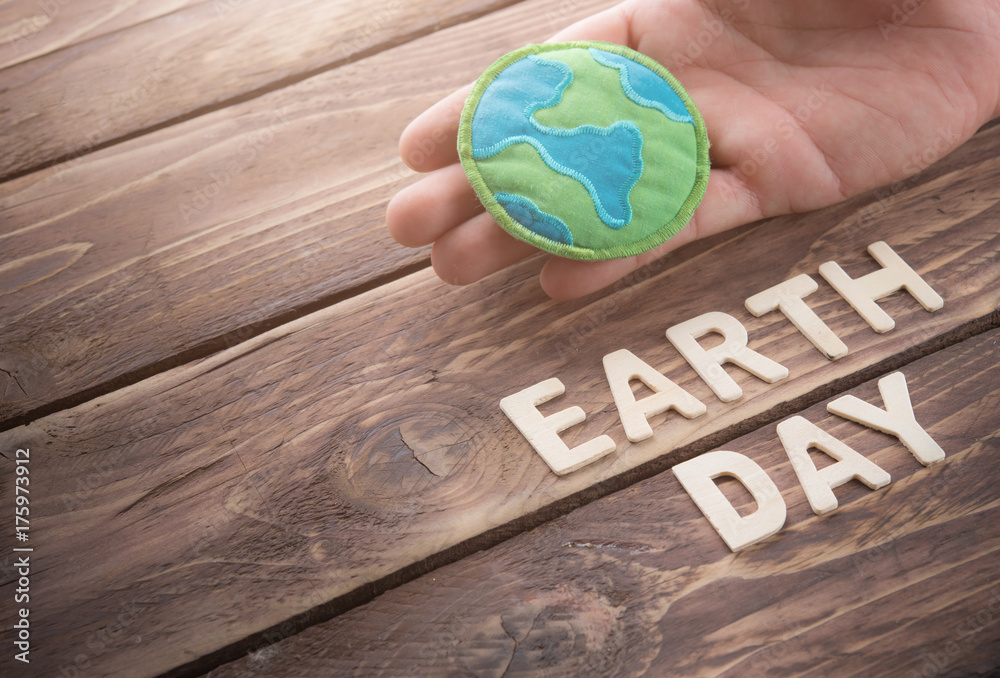 Earth day word with fabric earth globe on wood background, earth day ...
