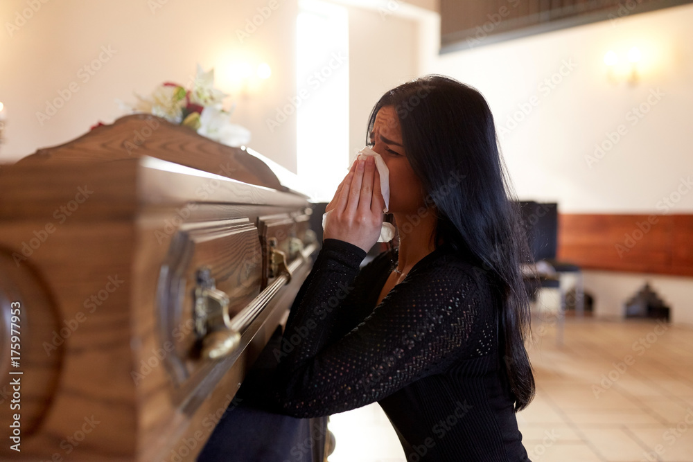 woman with coffin crying at funeral in church Stock Photo | Adobe Stock