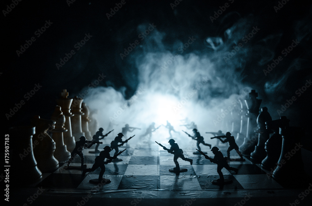 War concept. Silhouettes of soldiers on chessboard. War Concept ...