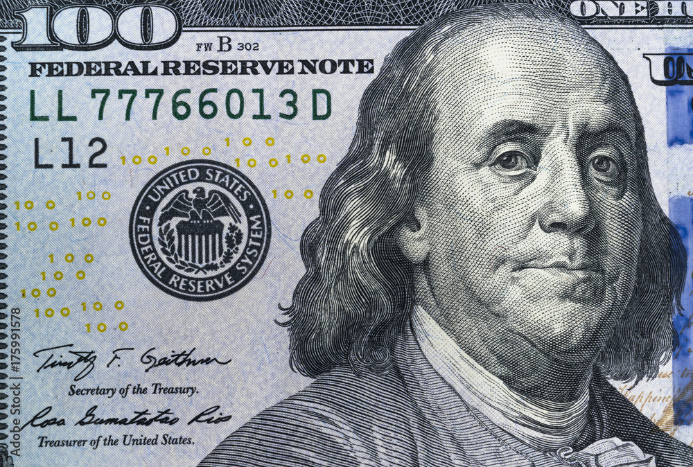 Close up overhead view of Benjamin Franklin face on 100 US dollar bill. US one hundred dollar ...