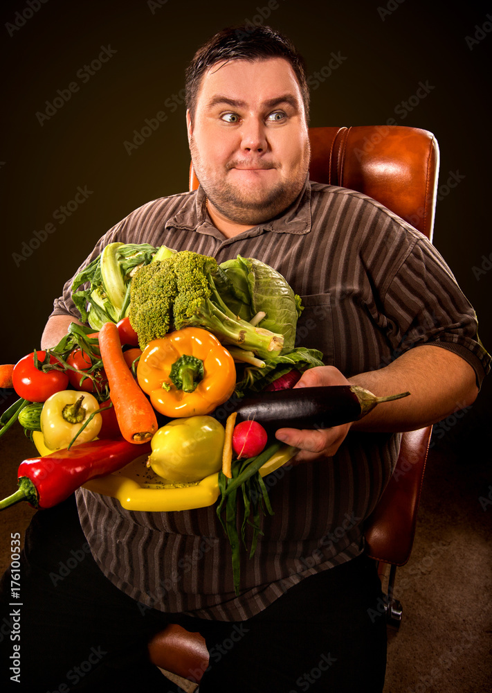 Diet fat man eating healthy food with vegetables cauliflower and sweet ...