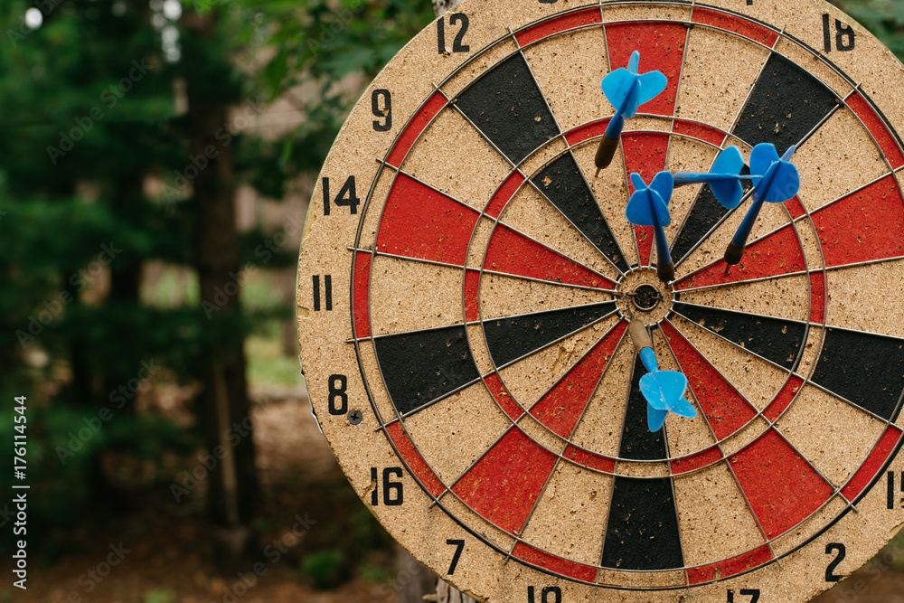 Darts in a dartboard outdoors Stock Photo | Adobe Stock
