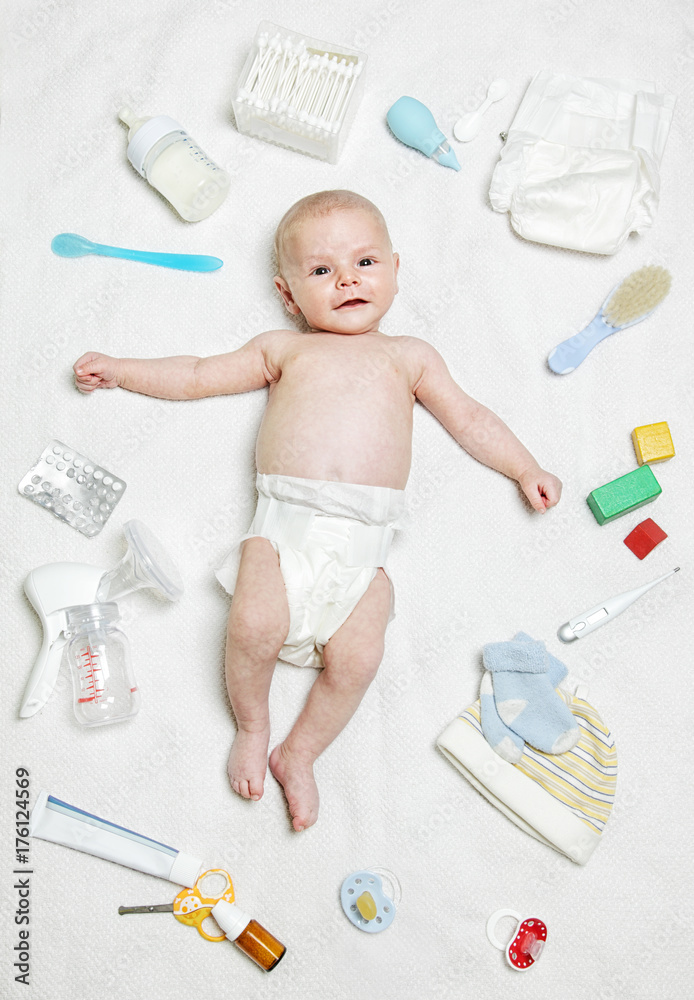 One Month old Baby Boy in diaper on white towel surrounded by ...