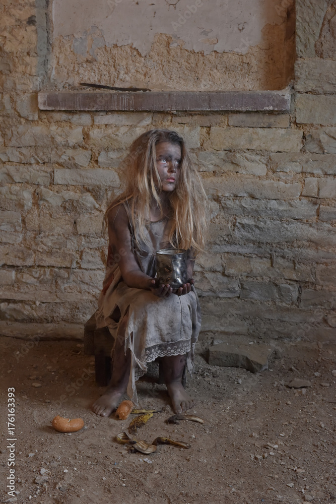 A scene of child poverty amongst children. The child is seen to be ...