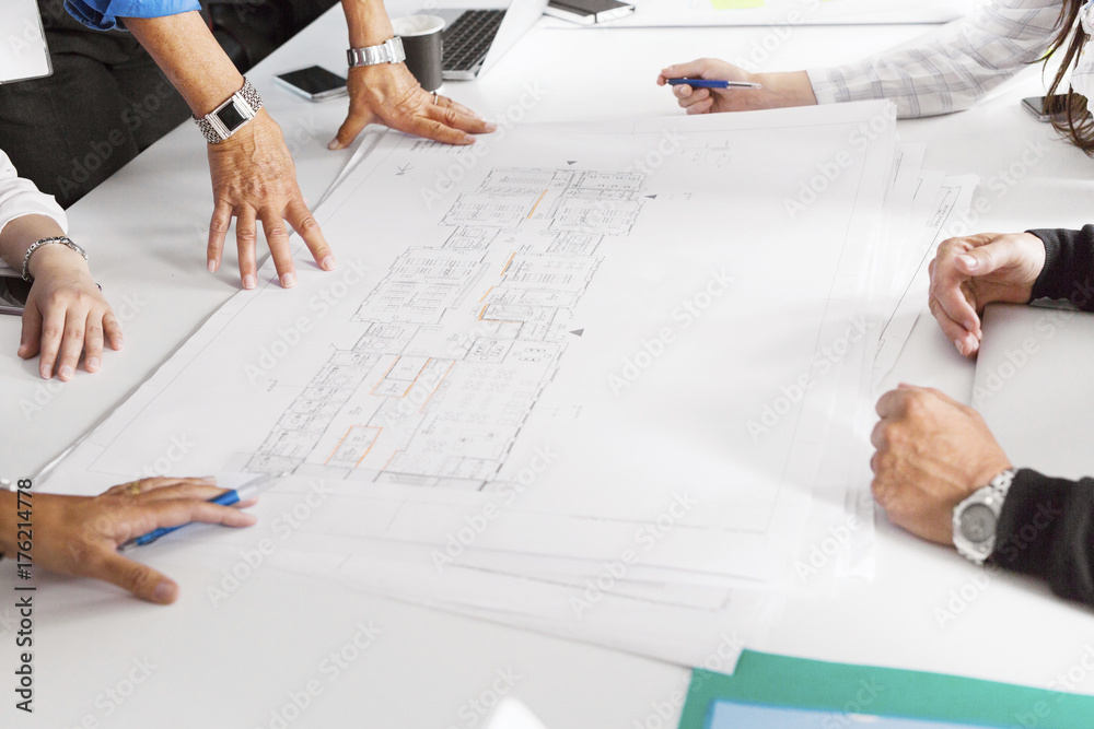 Team of architects looking at blueprint Stock Photo | Adobe Stock
