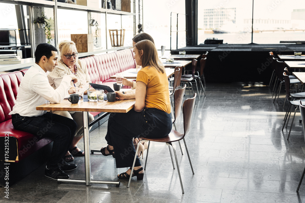 Four colleagues eating lunch in cafeteria Stock Photo | Adobe Stock