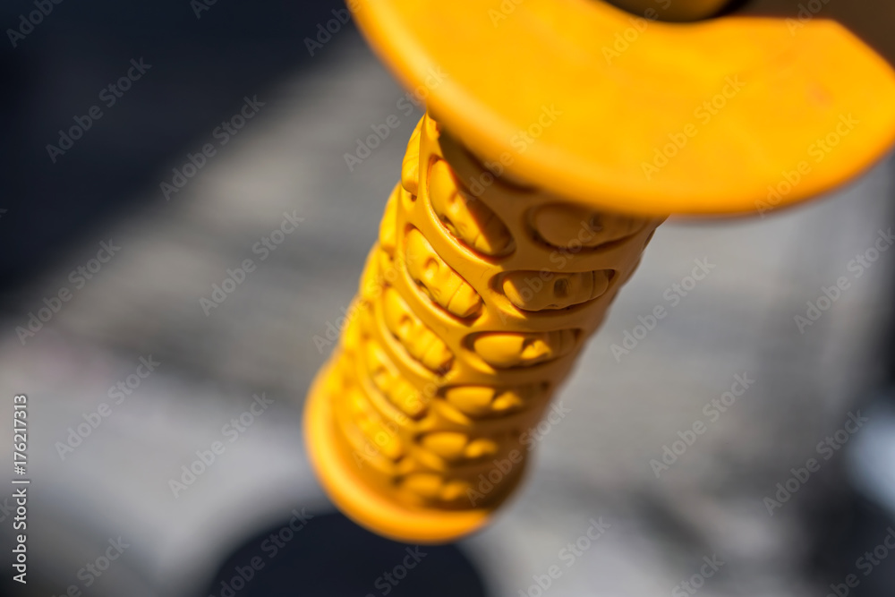 macro detail of yellow handlebars with form of skull of a black fixie ...
