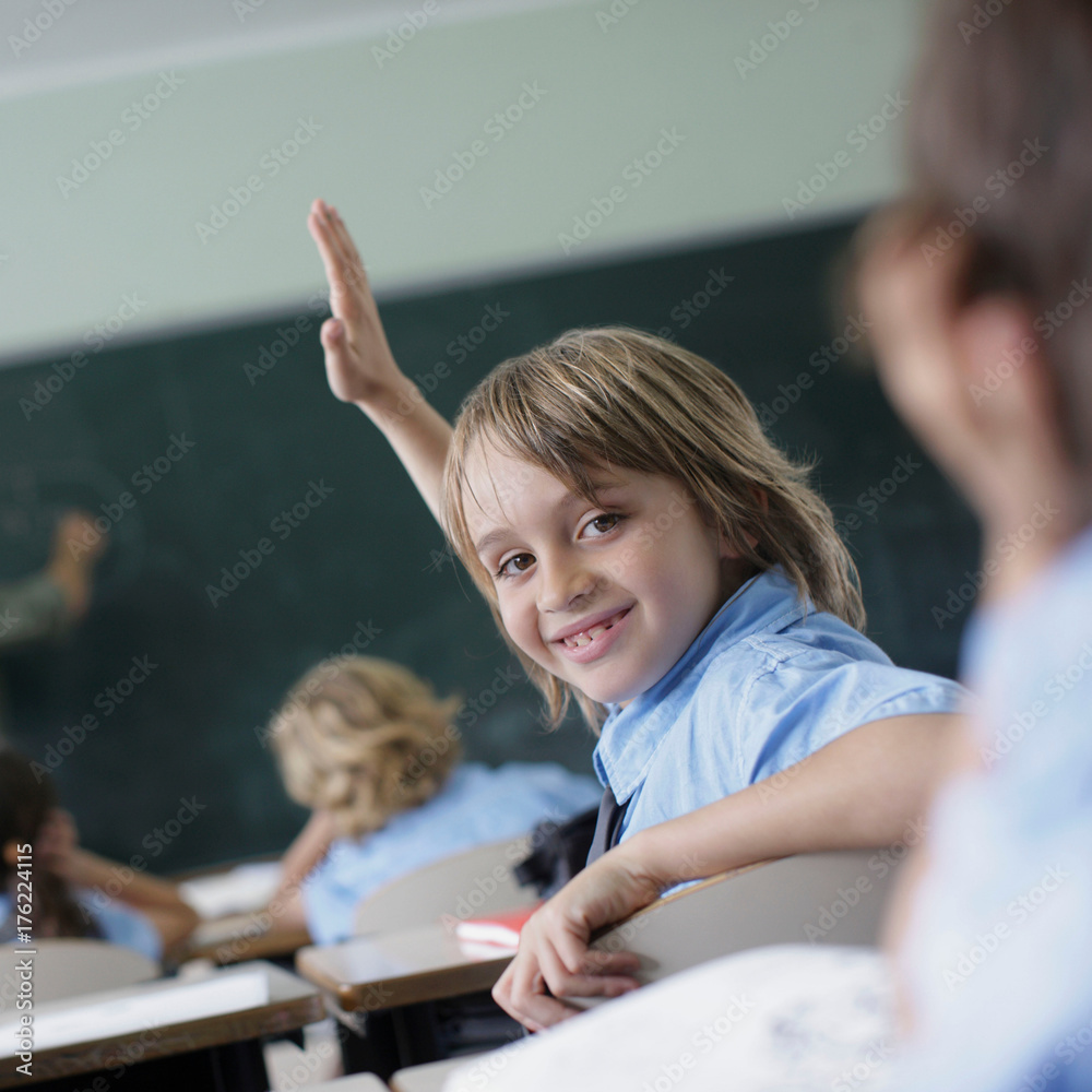 Boy Raising Hand In Class