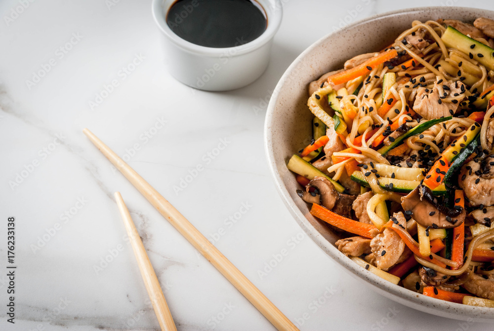 Traditional Asian food. Lunch stirfry: rice noodles, zucchini, carrots ...