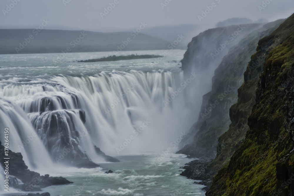 A number of steep cliffs on the right and a huge waterfall. Gloomy ...