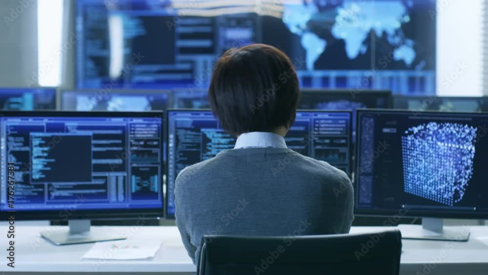 In the System Control Room Technical Operator Works at His Workstation ...