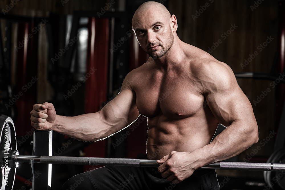 Attractive muscular bodybuilder guy prepare to do exercises with ...