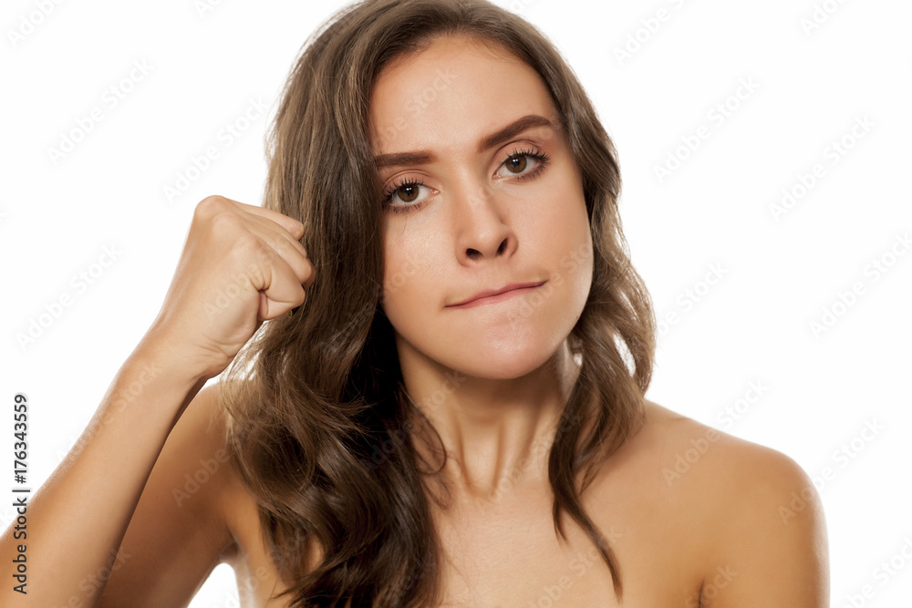 Portrait of beautiful young angry woman with clenched mouth on white ...