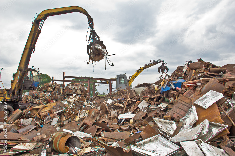 Sorting and loading of scrap metal./Excavator is loading scrap metal ...