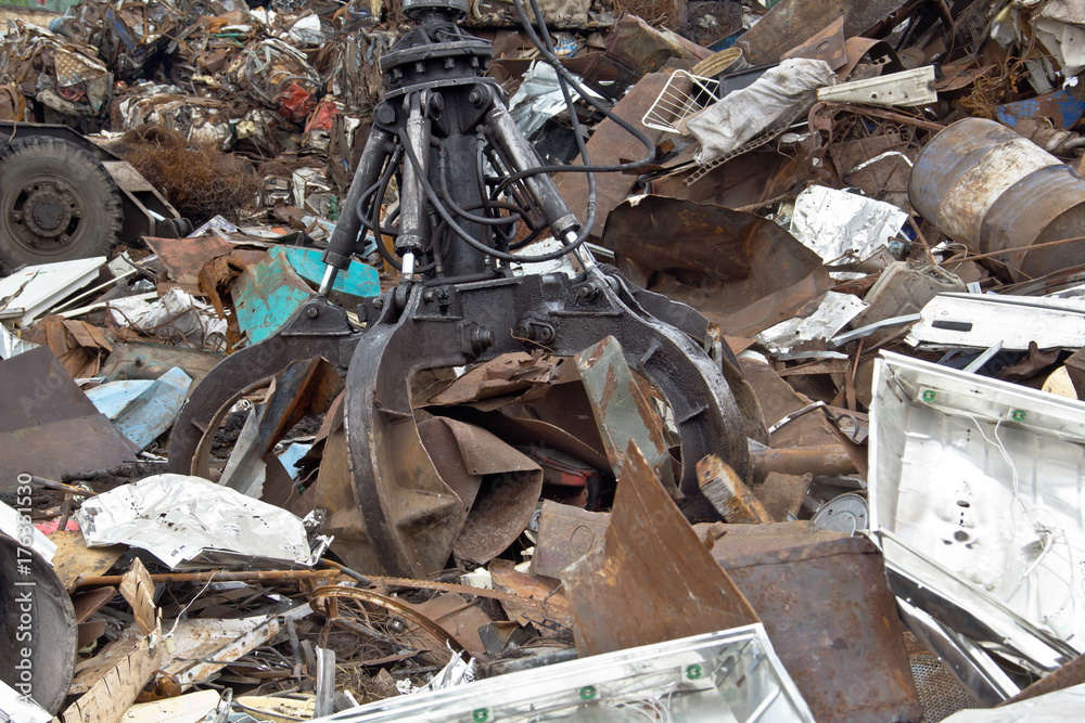 Sorting and loading of scrap metal./Excavator is loading scrap metal ...