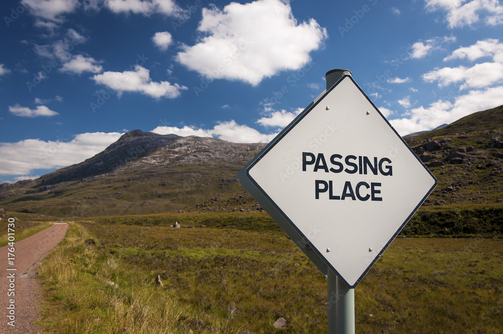 A Passing Place road sign in a narrow country road in the Highlands of ...