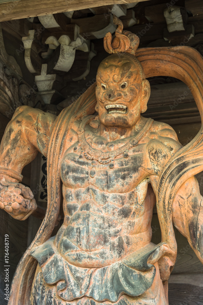 Giant statue guarding the gate at Daisho-in Temple, Miyajima, Japan ...