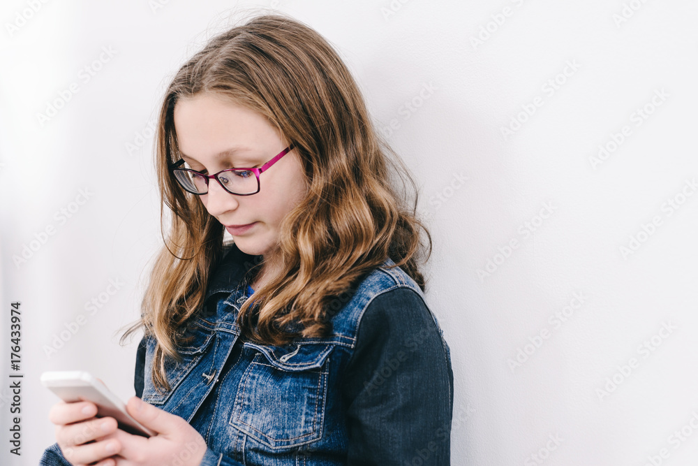 tween girl glued to her mobile phone Stock Photo | Adobe Stock