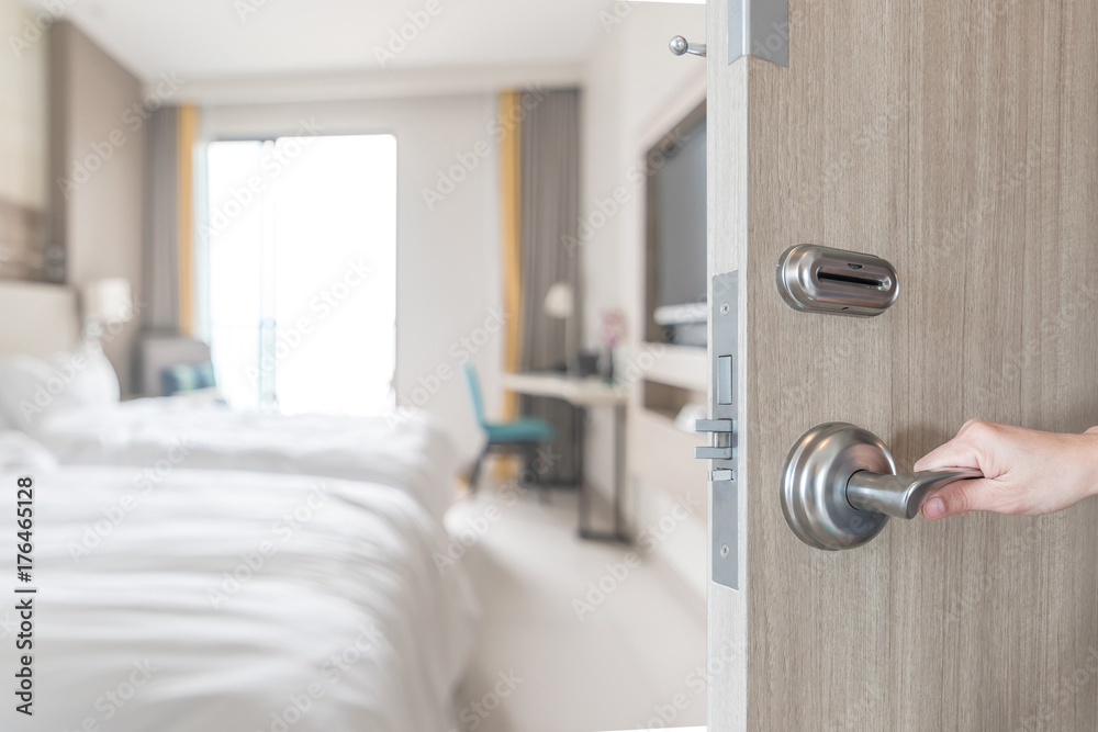 Hotel room door opened unlock to guest bedroom interior view with blur ...