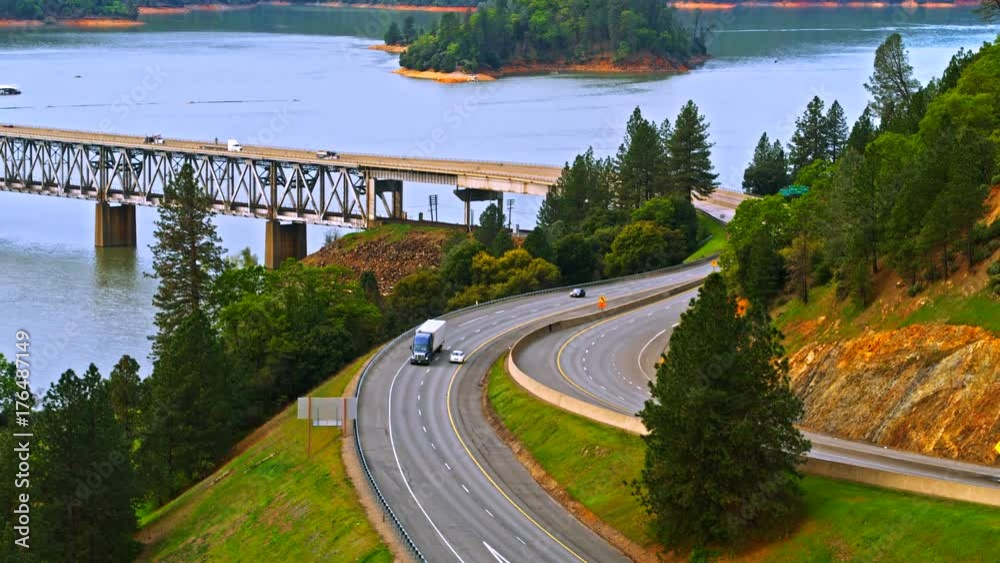 Vehicles driving on Pit River Bridge double deck road and rail bridge ...
