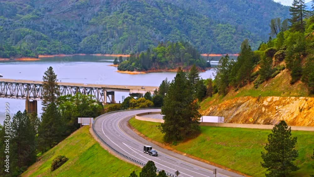 Vehicles driving on Pit River Bridge double deck road and rail bridge ...