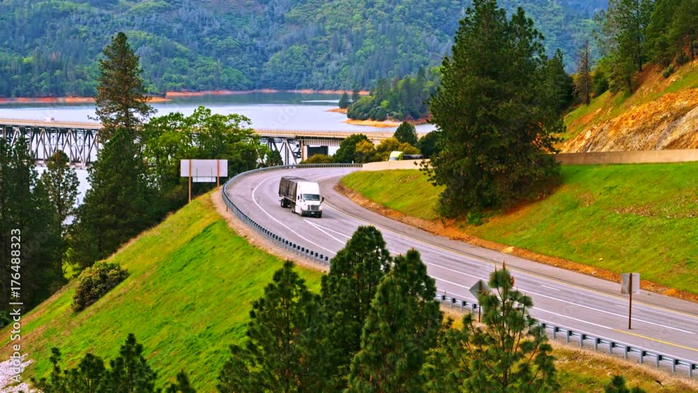 Vehicles driving on Pit River Bridge double deck road and rail bridge ...