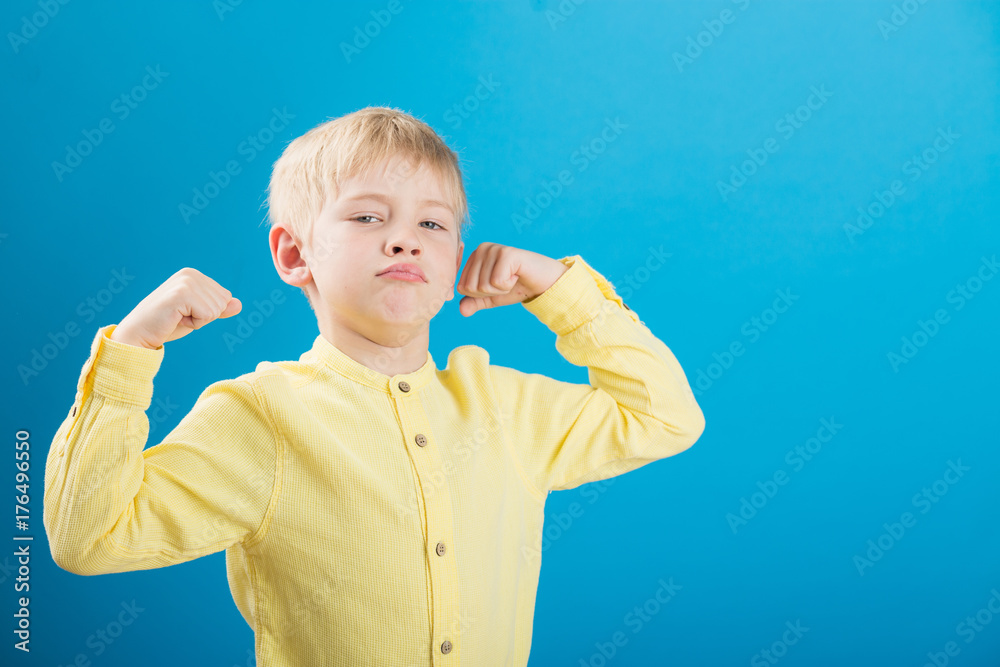 Boy is showing his arm muscles. Portrait of the boy of the European ...
