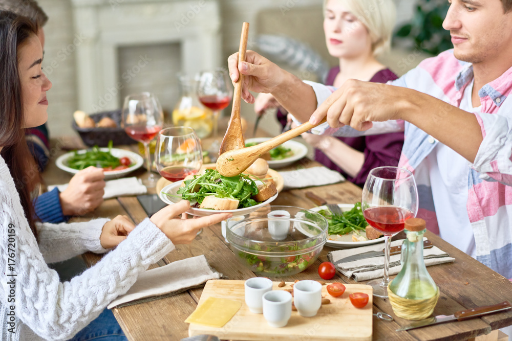 Portrait of four people eating at festive dinner table with delicious ...