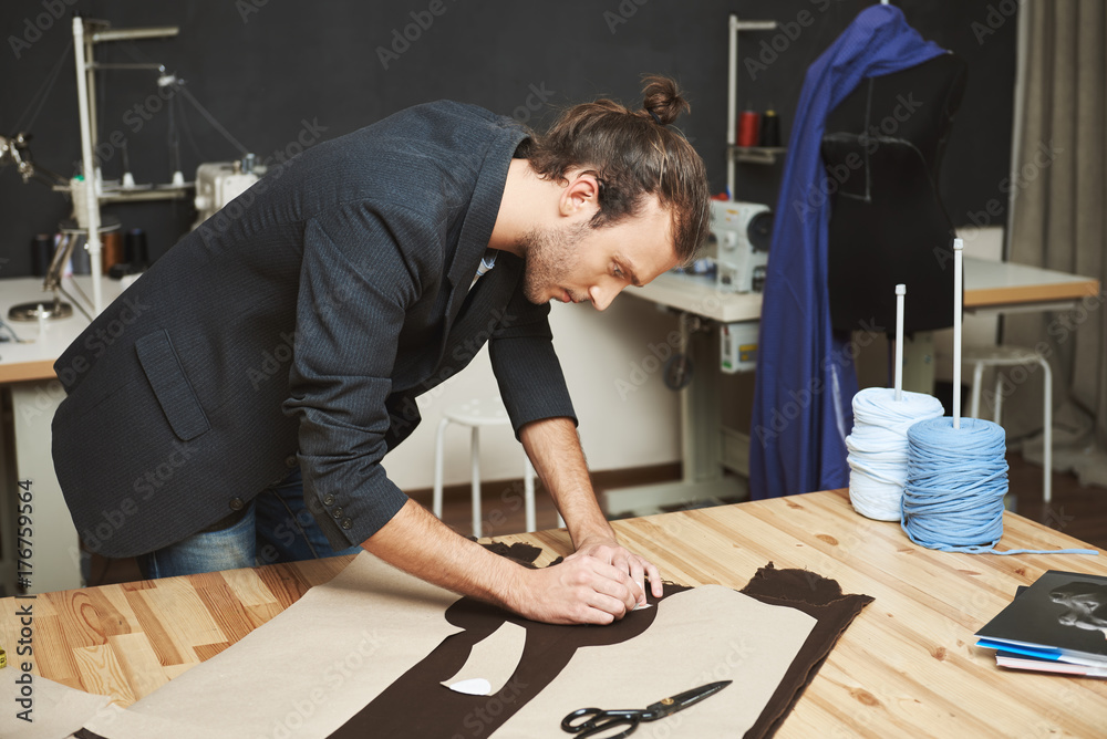 Portrait of manly good-looking adult male clothes designer with stylish ...