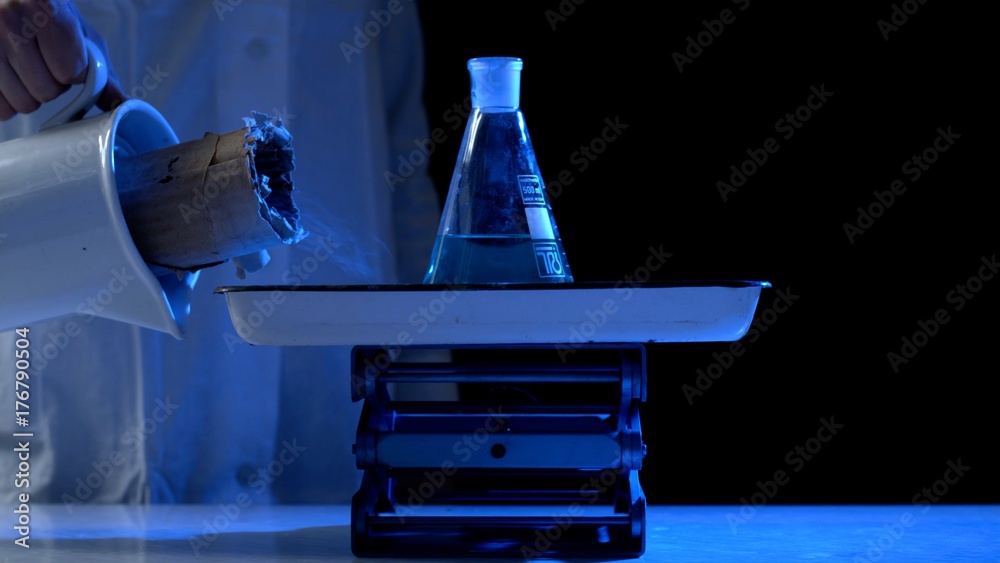 Bottle and liquid nitrogen in a laboratory. Chemical experiment. Flask ...