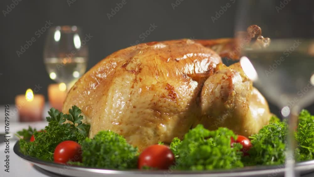 Thanksgiving or Christmas turkey dinner. Whole roasted turkey steaming on tray. Browned turkey ...
