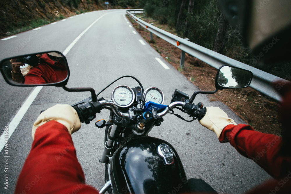 View of experienced motorcycle driver riding his vehicle through ...