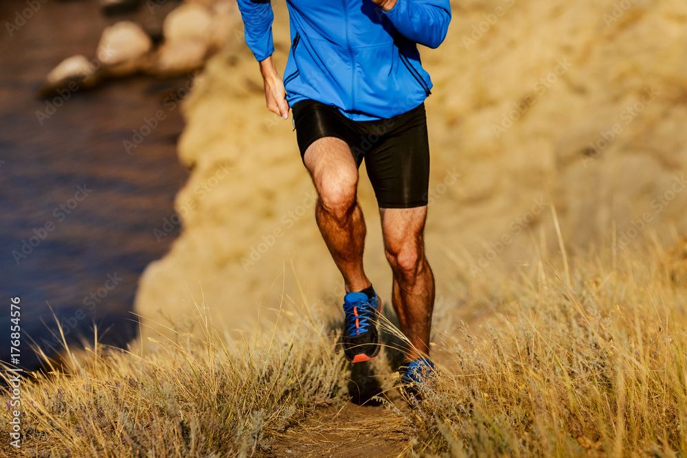 muscular legs of runner man running on trial mountain sea bay Stock ...