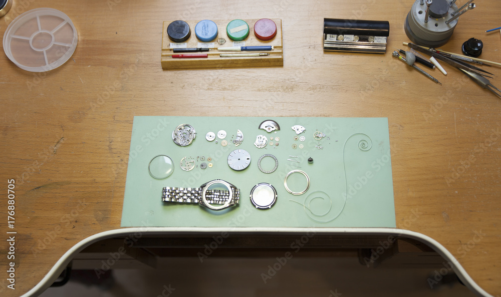 Parts of deconstructed watch lying on clockmaker table Stock Photo ...